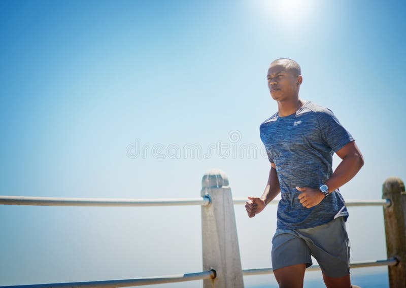 Dedicated and Determined. a Young Sporty Man Running Outside. Stock ...