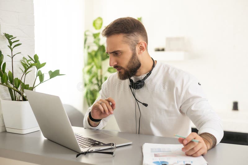 Dedicated Entrepreneur Sitting at Office Desk and Reading an E-mail ...