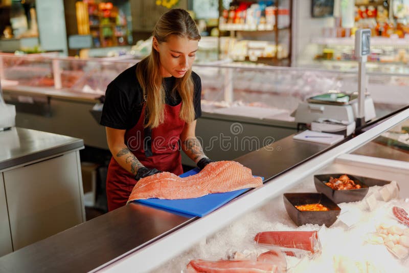 A Dedicated Fishmonger is Skillfully Preparing an Array of Fresh and ...