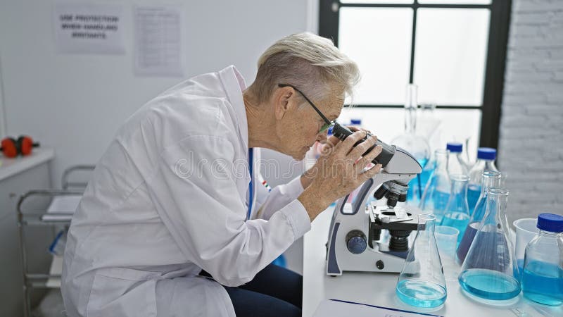 Dedicated Grey-haired Senior Woman Scientist Immersed in Intense ...