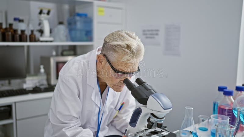 Dedicated Grey-haired Senior Woman Scientist Immersed in Intense ...