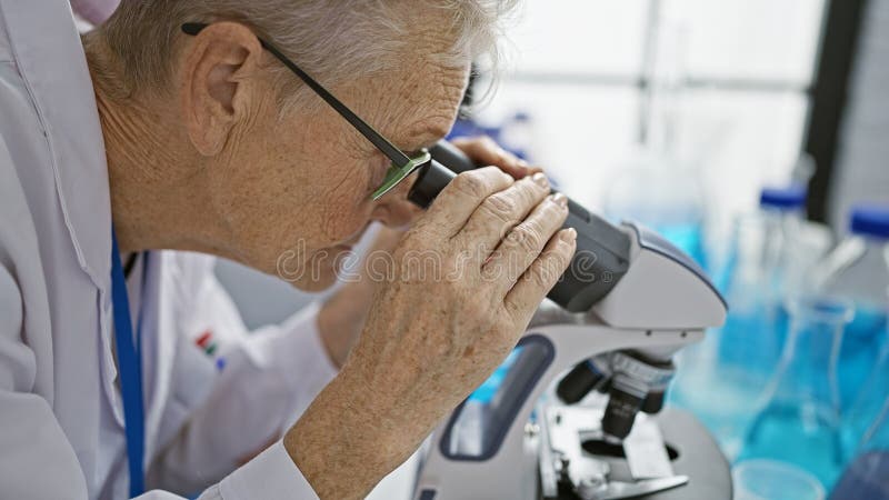Dedicated Grey-haired Senior Woman Scientist Immersed in Intense ...