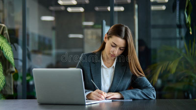 Dedicated Professional Writing in Notebook, Planning Tasks and Managing ...