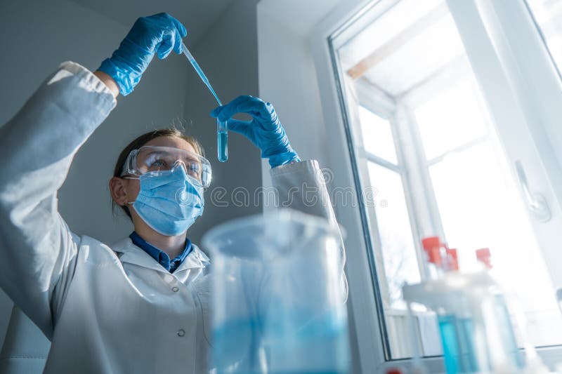 A Dedicated Scientist is Conducting an Experiment within a Wellequipped ...