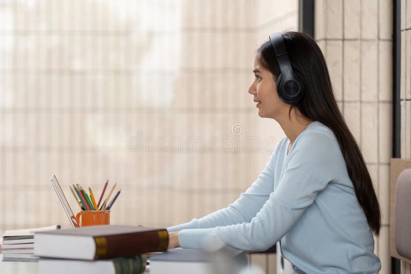 Focused Study and Online Learning. Young Woman Wearing Headphones, Deeply Engaged in Her Studies ...