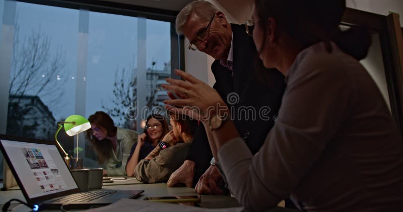A Dedicated Team Collaborates on Projects in a Well-lit Office Space ...