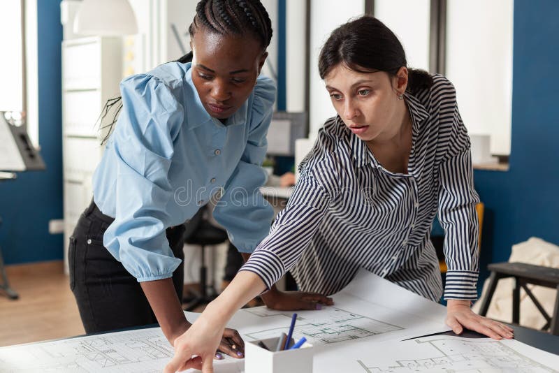 Dedicated Team of Engineers Colleagues Discussing Construction Plans ...