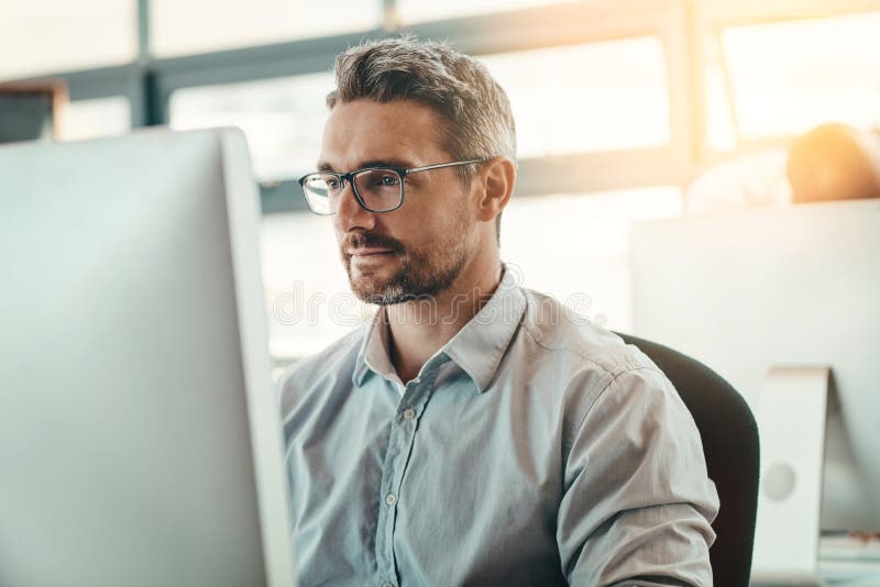 Dedicated To Making the Day a Productive One. a Mature Businessman ...