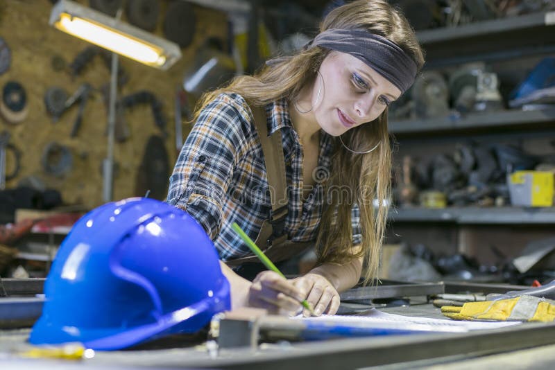 Dedicated Woman Working in Workshop Stock Photo - Image of hair, female ...