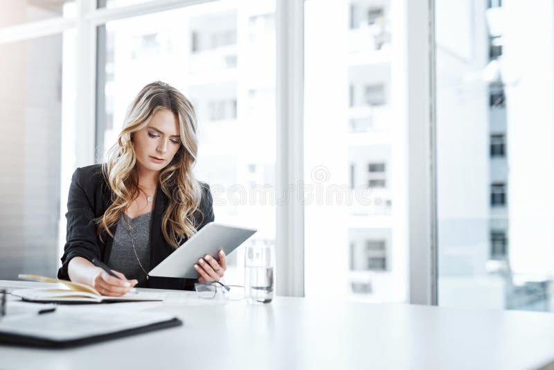 Dedication Gets the Job Done. a Young Businesswoman Using a Digital ...