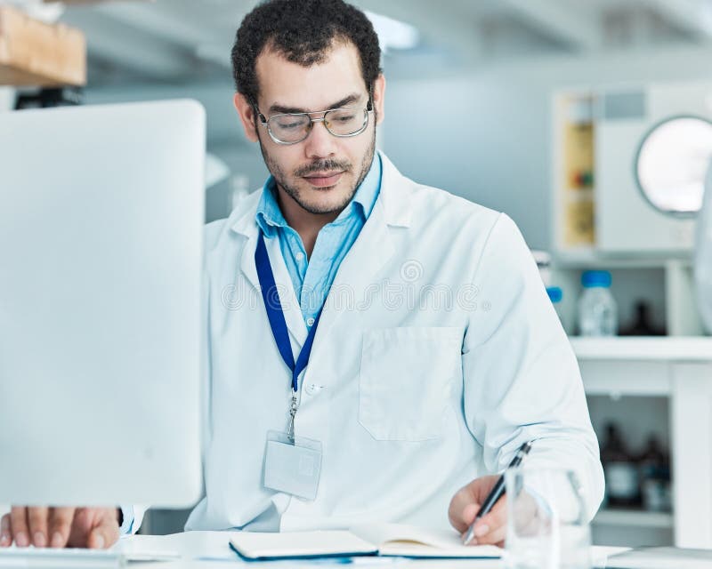 Deducing the Facts. a Young Scientist Writing Notes while Working on a ...
