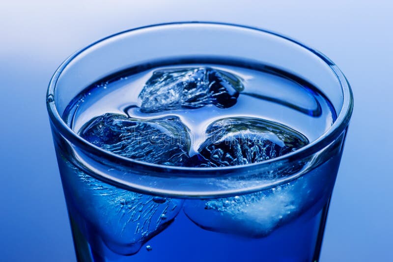 Deep Blue Colored Drink with Ice on Abstract Blue Background. Stock ...