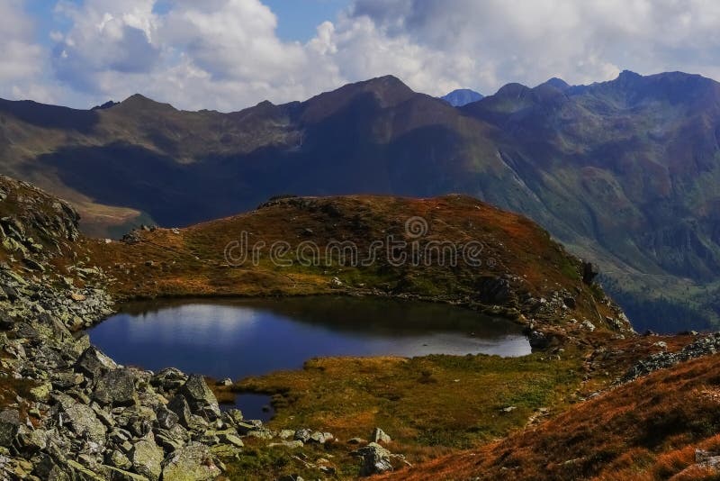 Deep Blue Mountain Lake with Reflections in Colorful Mountains Stock ...