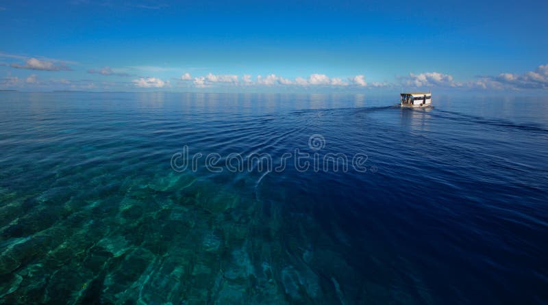 Deep blue ocean and boat stock photo. Image of secluded - 14103474