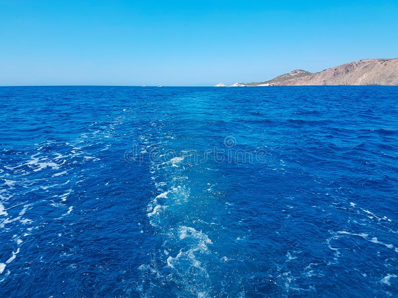Deep Blue Sea and Island with Small Bushes View from Back of a Stock ...