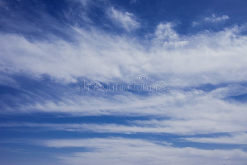 A Deep Blue Sky with Light White Clouds Background Stock Image - Image ...