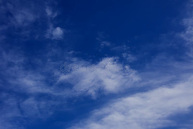 A Deep Blue Sky with Light White Clouds Background Stock Image - Image ...