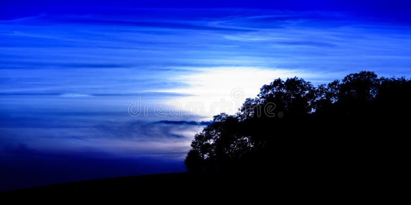 Deep Blue Sunset Over Trees Stock Photo - Image of deep, cold: 83286582