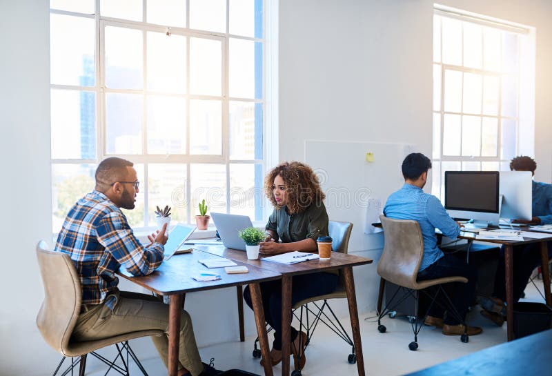 Deep in a Creative Discussion. Two Young Coworkers Having a Discussion ...