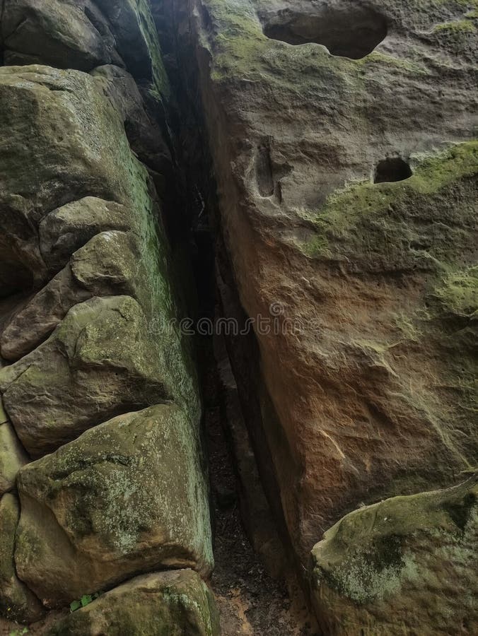 A Deep Crevice Separates Two Large Rock Formations Covered in Moss ...