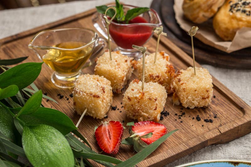 Deep Fried Camembert Cheese Cubes with Cranberry Sauce and Honey on the ...