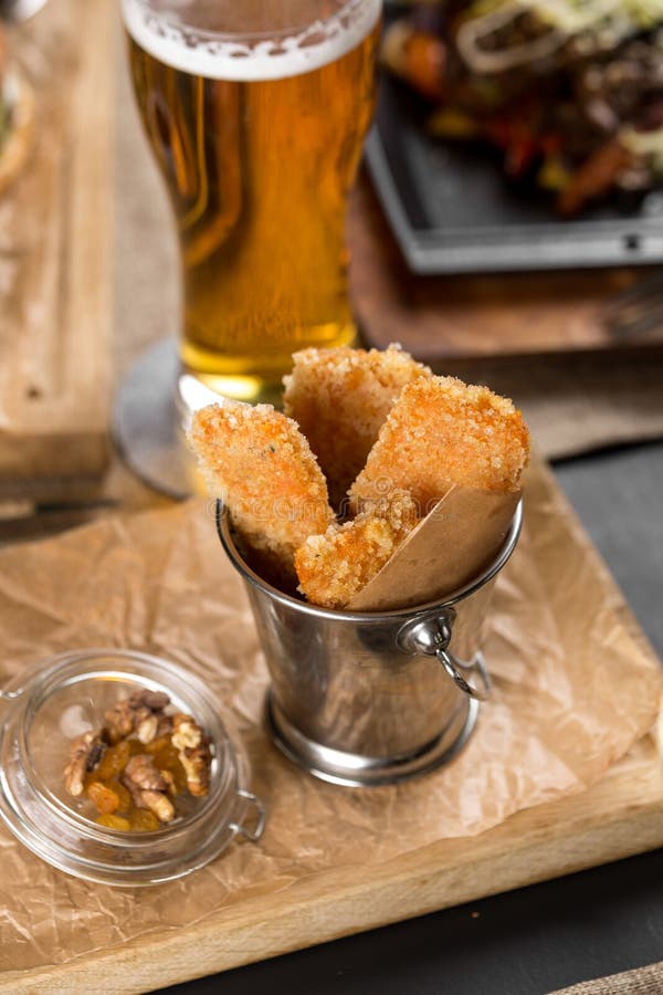 Deep Fried Cheese Sticks with Glass of Beer on the Table at Restaurant ...