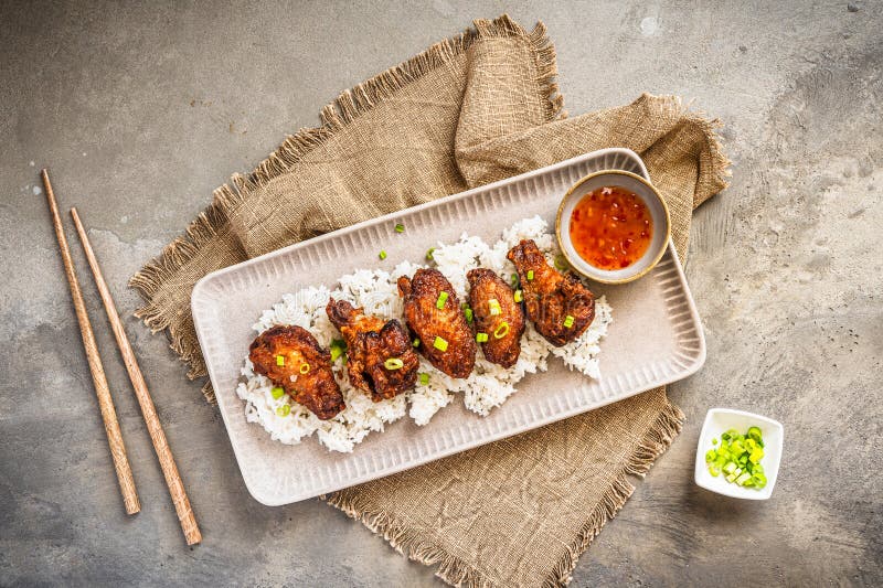 Deep Fried Chicken Wings on Rice on Rustic Gray Concrete Background ...
