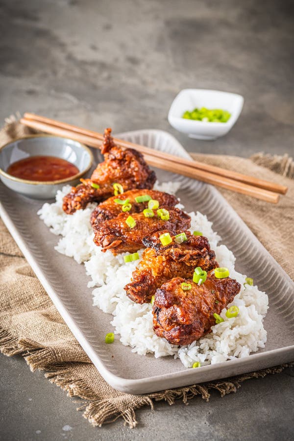Deep Fried Chicken Wings on Rice on Rustic Gray Concrete Background ...
