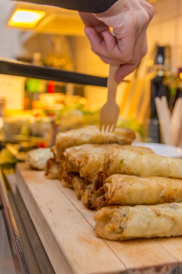 Deep-Fried Chinese Homemade Spring Rolls Served on a Cutting Board ...