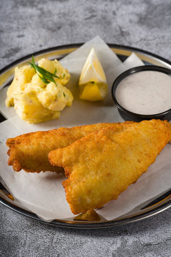Deep Fried Coated Fish Fillet with Potato Salad on Stone Table Stock ...