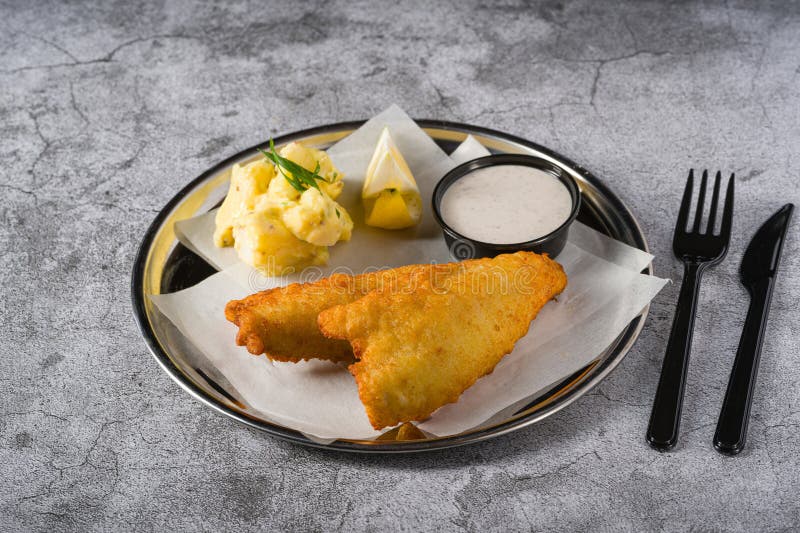 Deep Fried Coated Fish Fillet with Potato Salad on Stone Table Stock ...