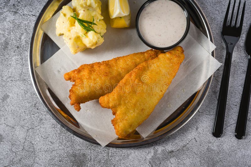Deep Fried Coated Fish Fillet with Potato Salad on Stone Table Stock ...