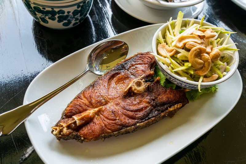 Deep Fried King Mackerel with Spicy Mango Salad - Thai Food Stock Image ...