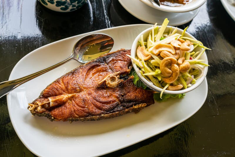 Deep Fried King Mackerel with Spicy Mango Salad - Thai Food Stock Photo ...