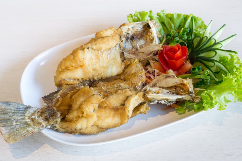 Deep Fried Snapper with Fish Sauce in White Dish on Stone Table Stock ...