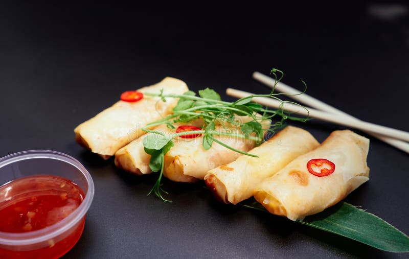 Deep Fried Spring Rolls with Red Sauce on Black Background Stock Photo ...
