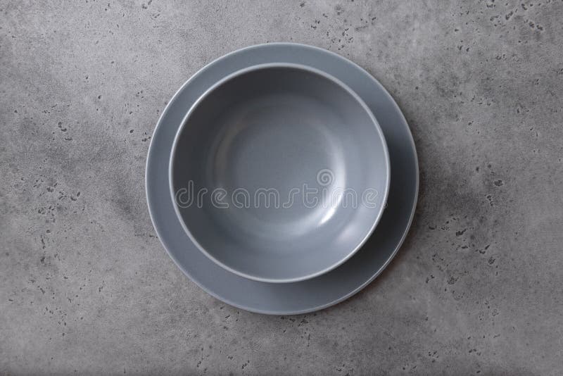Deep Grey Plate on a Flat Grey Plate on a Grey Concrete Background ...