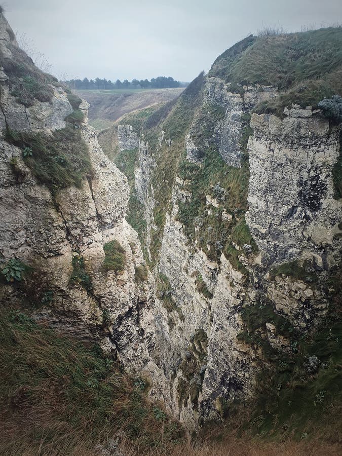 A Deep, Narrow Gorge with Steep, Rocky Cliffs Covered in Patches of ...
