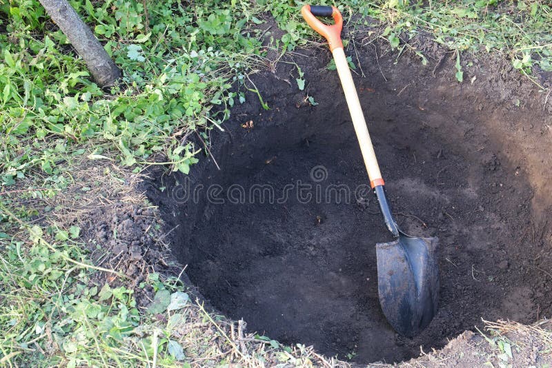 Deep Pit in the Ground. in the Pit Lies a Shovel Stock Image - Image of ...