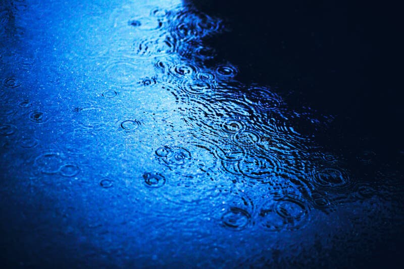 A Deep Puddle on the Asphalt, on the Surface of Which Raindrops Fall ...