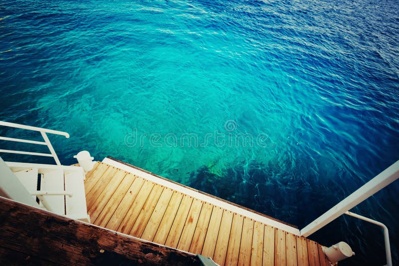 Deep sea and wooden pier stock photo. Image of ocean - 42790712