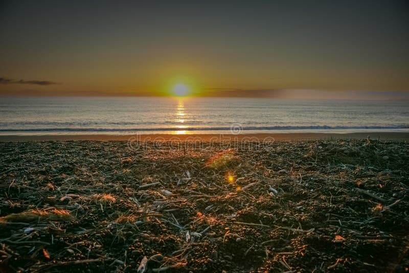 Deep Sunrise Over Stony Beach Stock Photo - Image of nature, gold ...