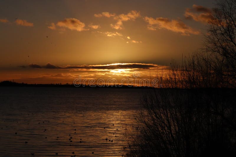 Deep Sunshine Setting Over Large Lake Stock Image - Image of lake ...