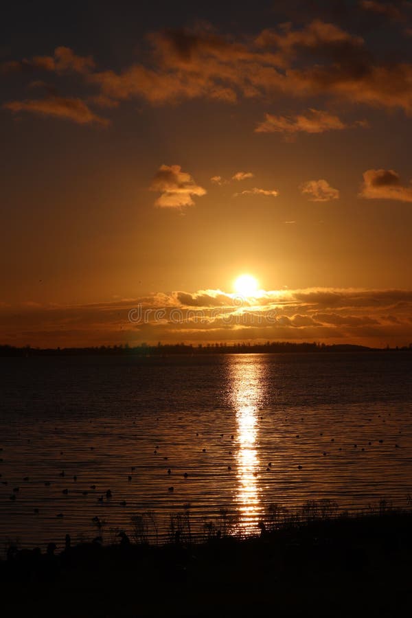 Deep Sunshine Setting Over Large Lake Stock Photo - Image of glowing ...