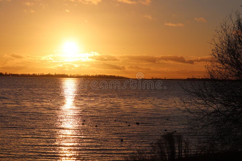 Deep Sunshine Setting Over Large Lake Stock Photo - Image of deep, lake ...