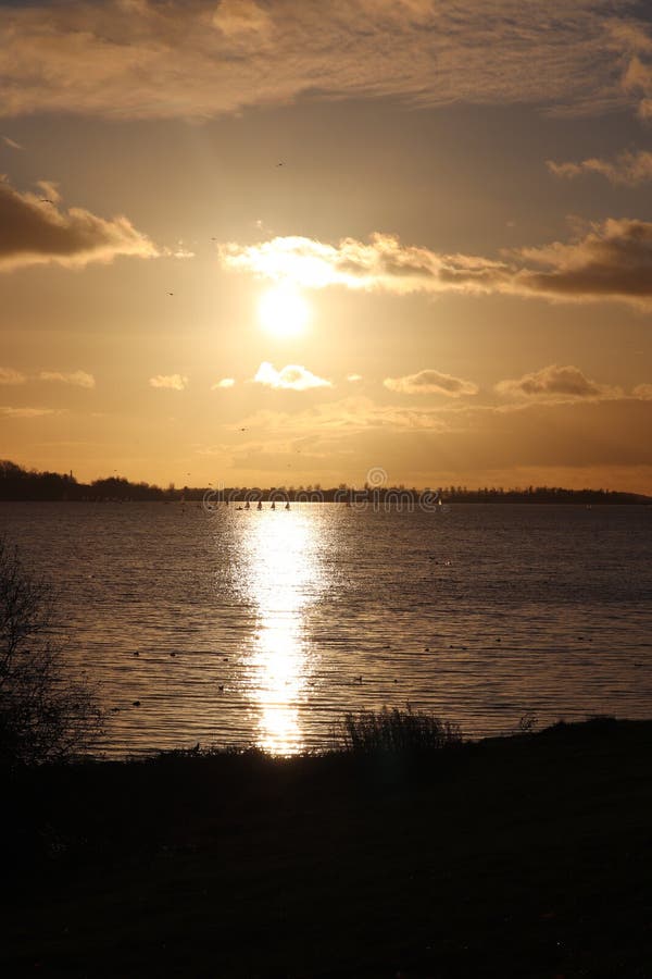Deep Sunshine Setting Over Large Lake Stock Image - Image of lake ...