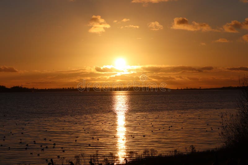 Deep Sunshine Setting Over Large Lake Stock Photo - Image of deep ...