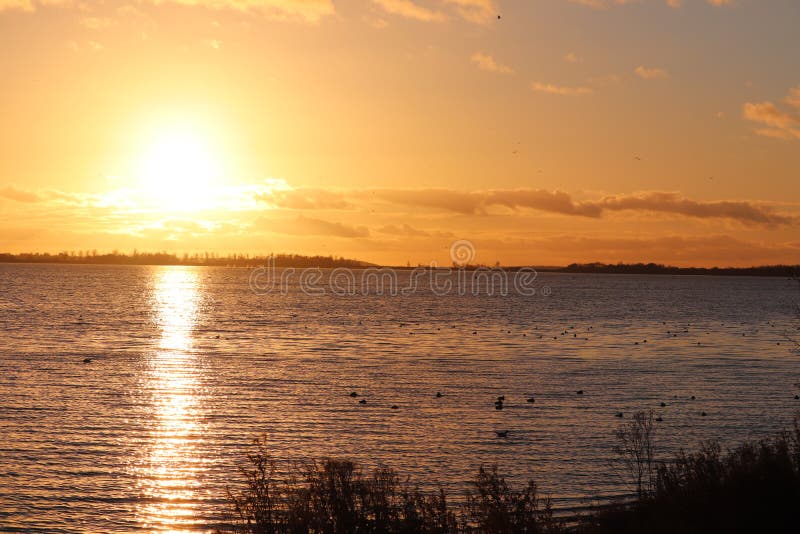 Deep Sunshine Setting Over Large Lake Stock Photo - Image of setting ...