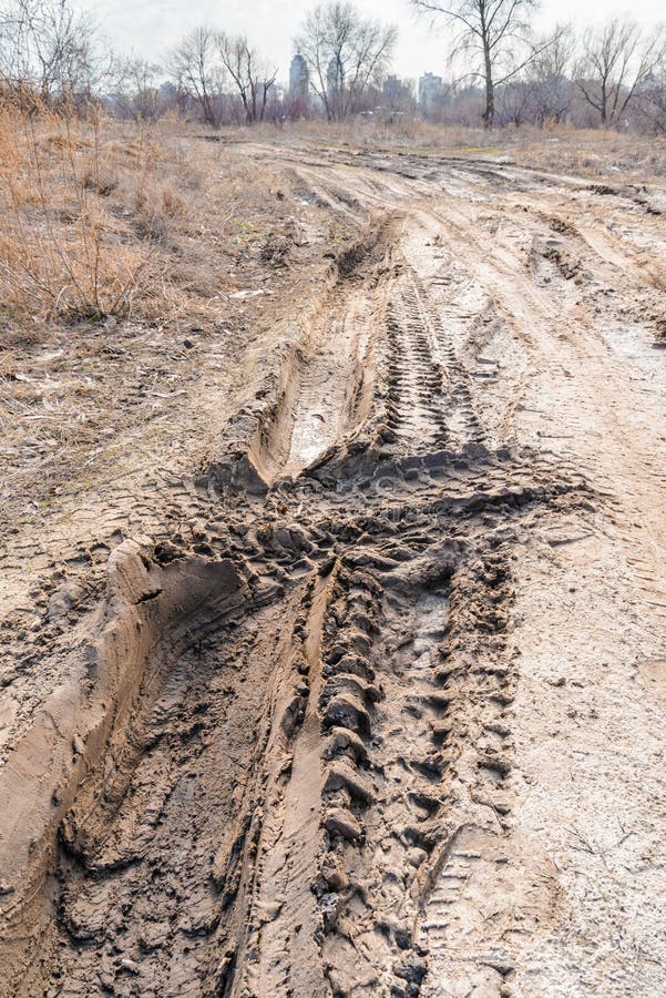 Deep Tires Tracks on the Road Covered by Wet Muddy Stock Image - Image ...