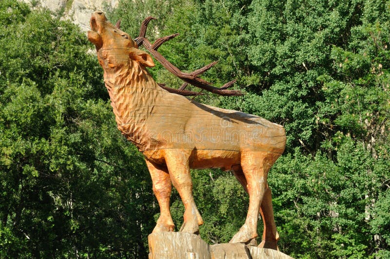 Deer statue in Valloire editorial stock image. Image of wood - 313011994